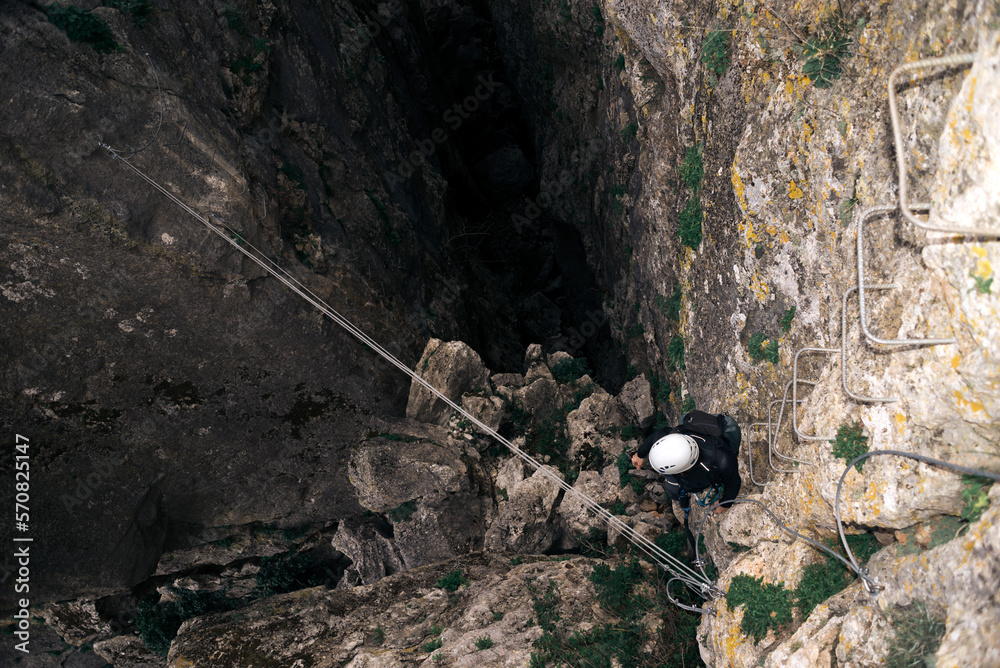 Concept: adventure. Climber man with helmet and harness. Aerial view of ...
