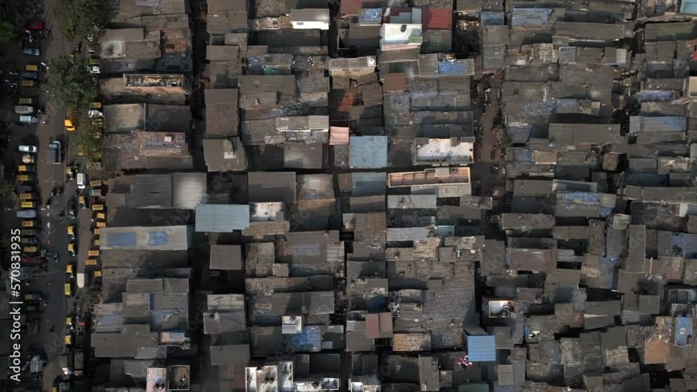 Top down aerial view of Dharavi slums next to busy road in Mumbai ...