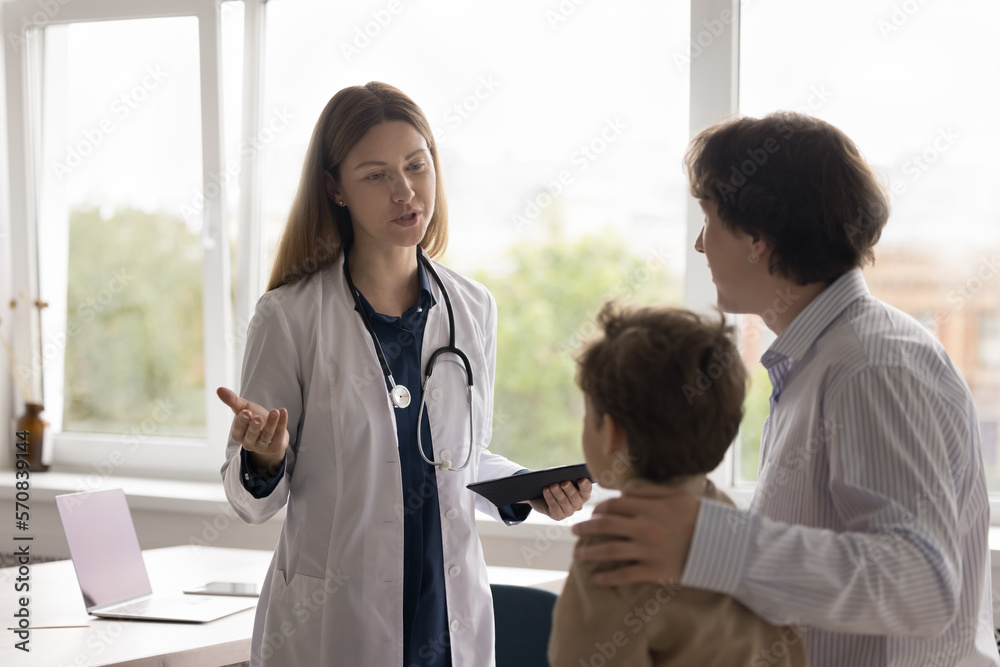 Positive pediatrician in white coat with stethoscope meeting with ...