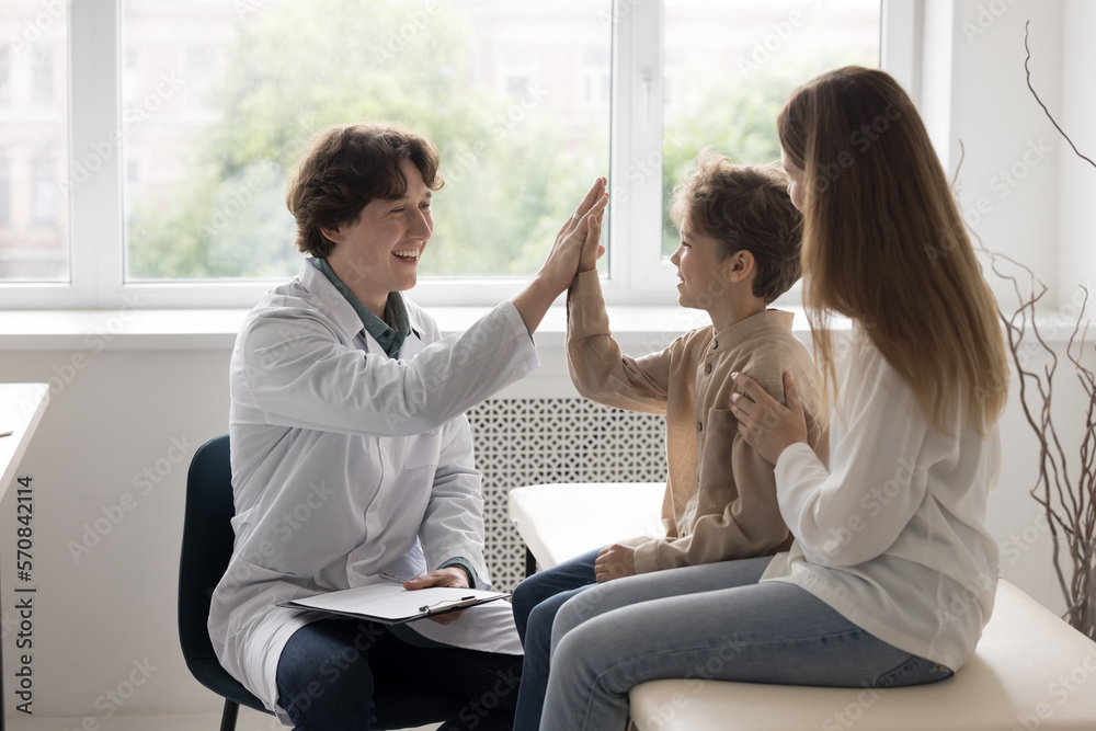 Happy proud doctor and cheerful healthy patient kid giving high five ...