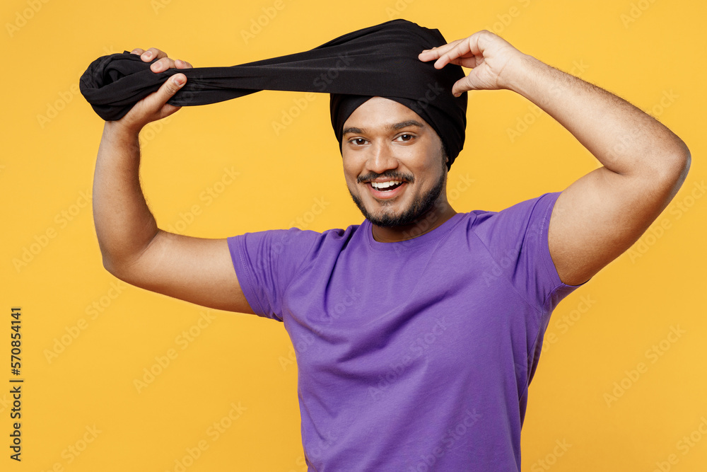 Smiling happy fun devotee Sikh Indian man show how to tie his ...
