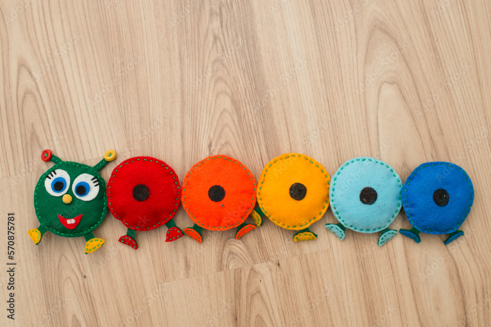 Happy hand made worm. Helminth made of different colors felt. Safe eco ...