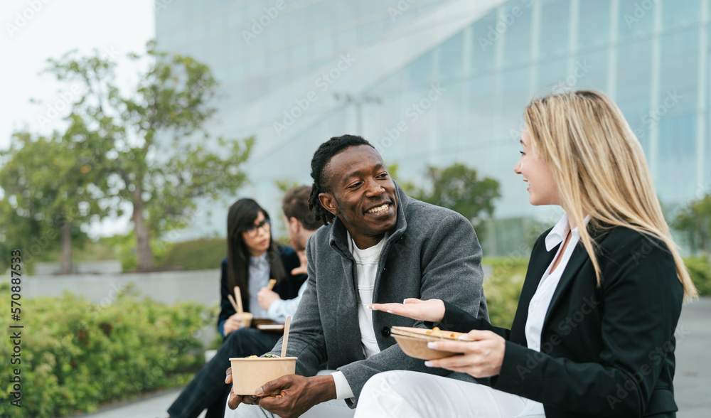 Happy business people having a lunch break outside office Stock Photo ...