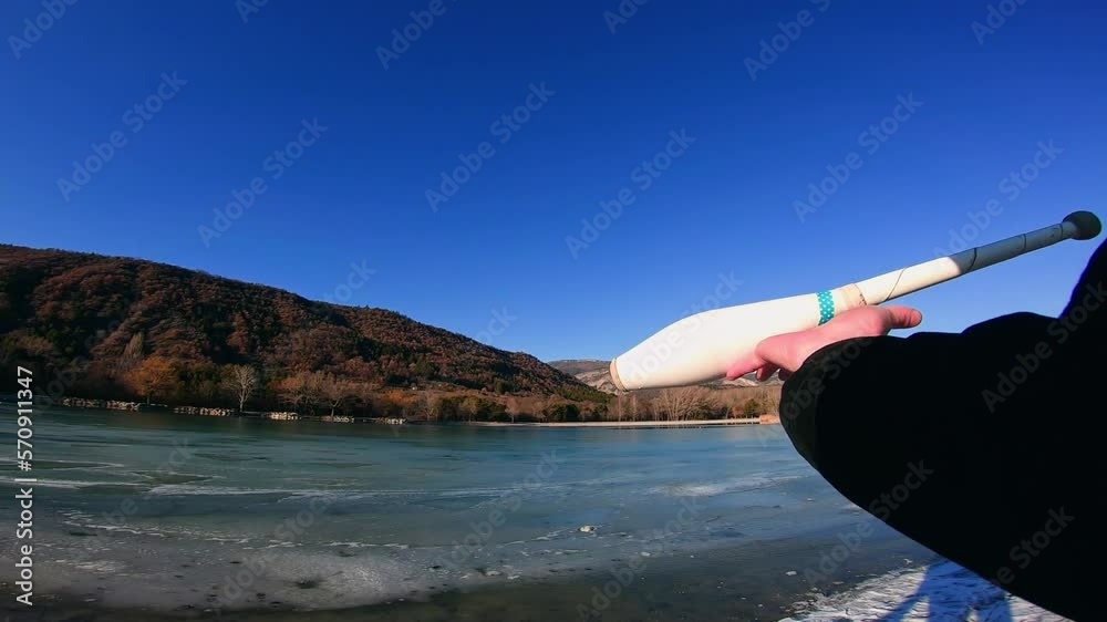 Immersive juggling 3 clubs and impressive fingers spinning trick viewed ...