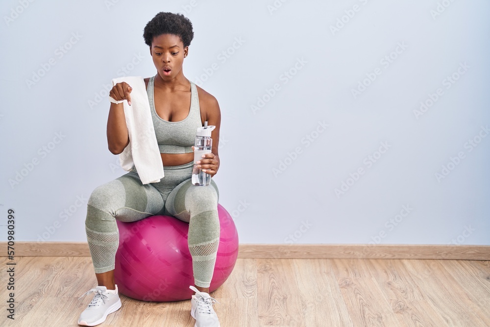 African American Woman Wearing Sportswear Sitting On Pilates Ball