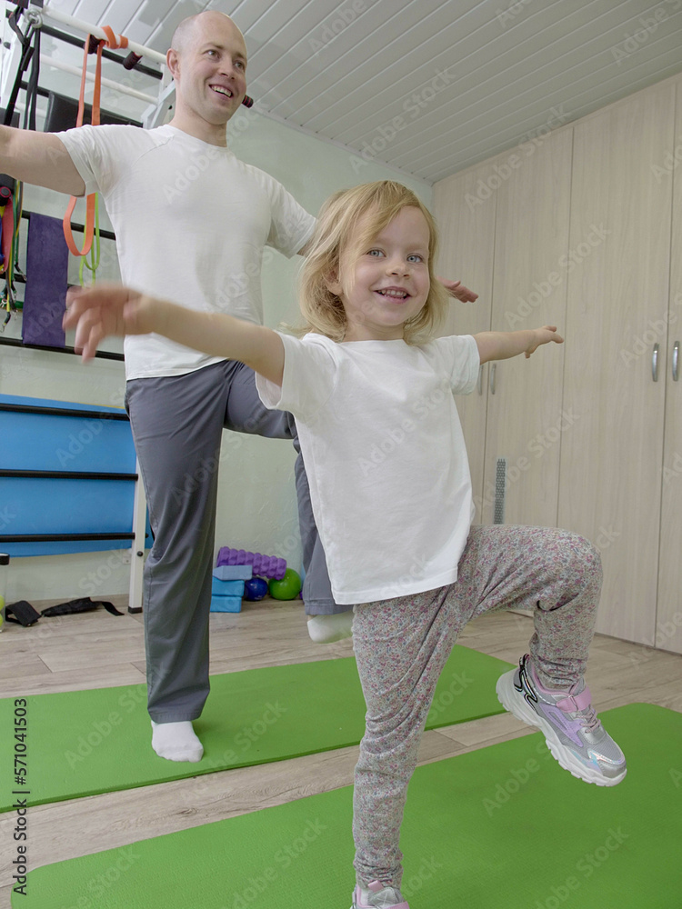 girl on physiotherapy in a children therapy center. Kid doing exercises ...