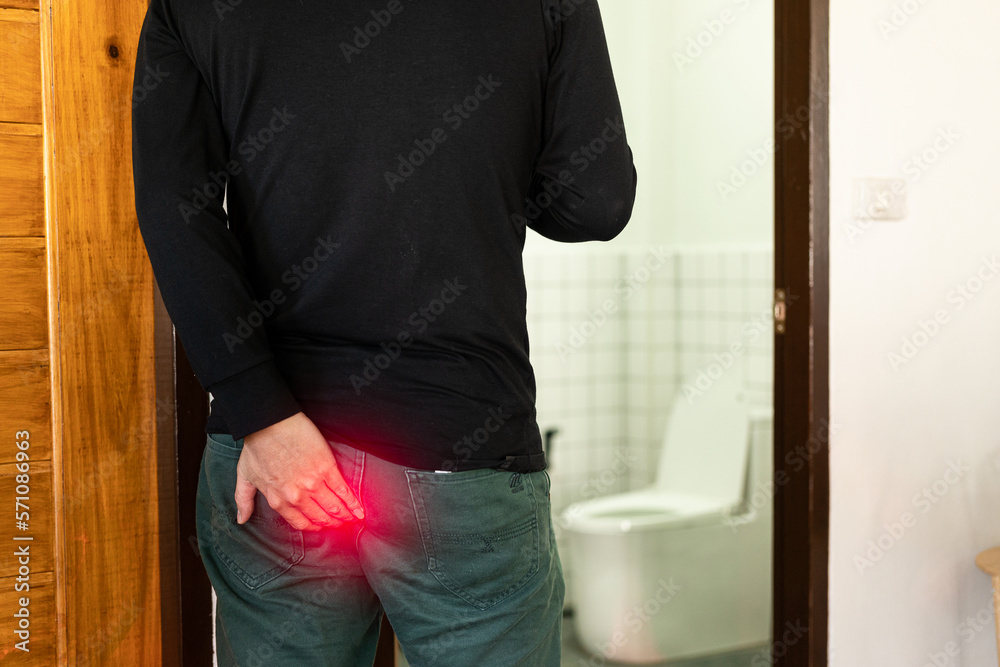 Young asian man suffering from hemorrhoids, diarrhea at the toilet ...