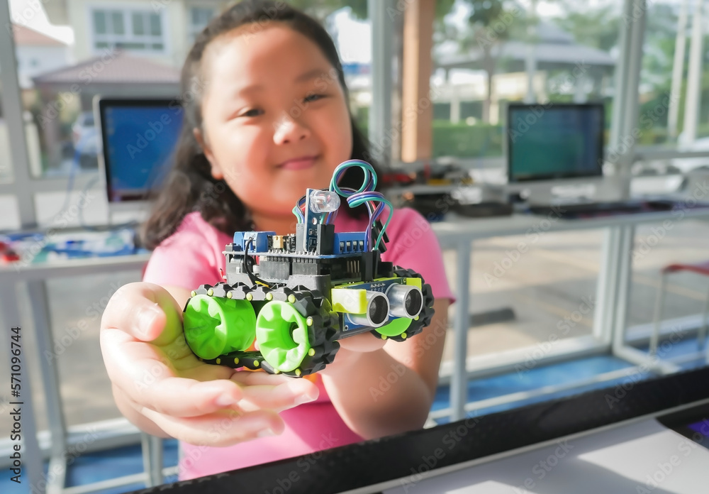 Asian girl learning coding and programming robotics to control her ...