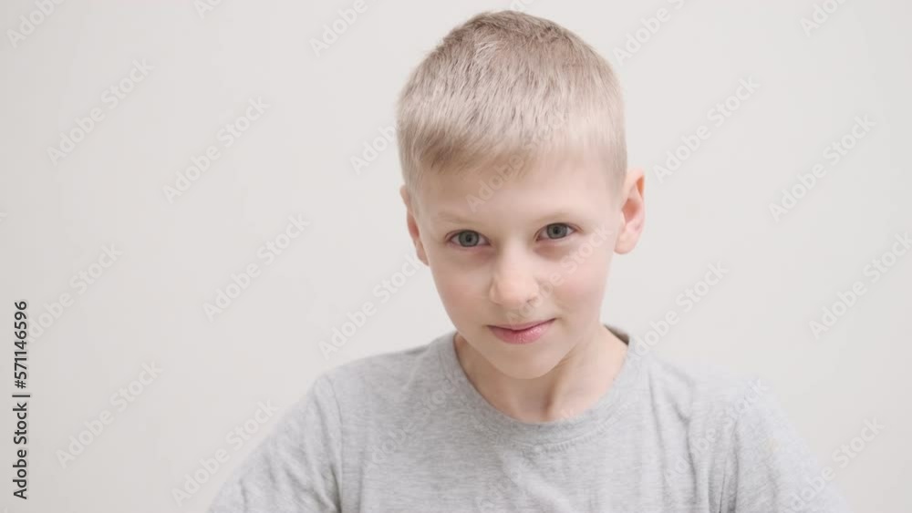 Frowning unhappy young caucasian child looking angry at camera. Upset ...