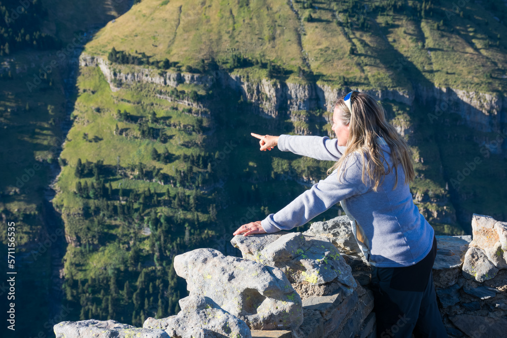 one woman pointing with her finger at a place of Ordesa national park ...