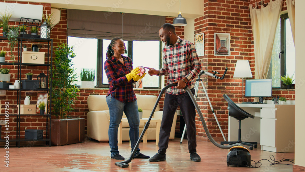 African american couple doing housework and chores, cleaning living ...
