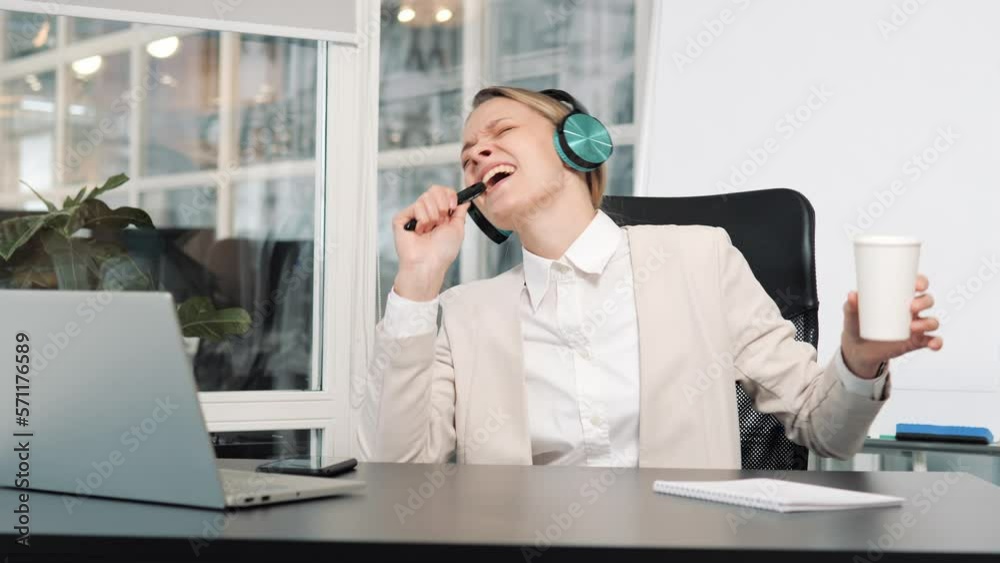 Cheerful happy positive adult woman dancing listening music in ...