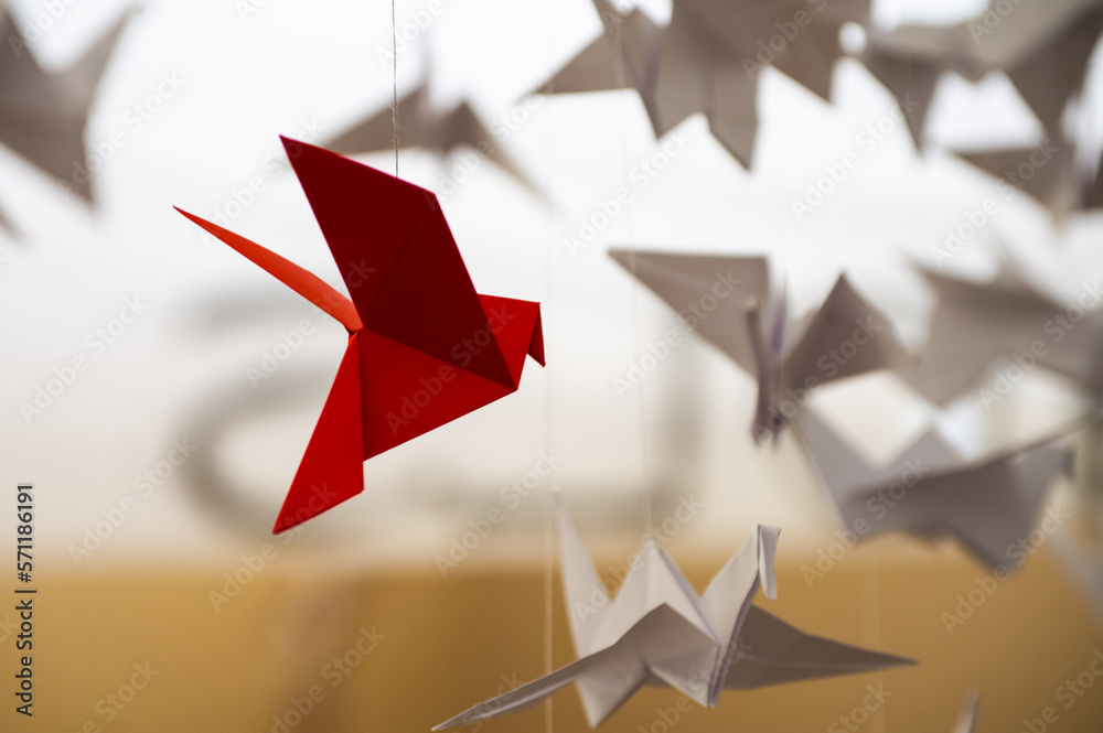 Japanese folded Origami cranes hanging on with strings. Hundreds ...