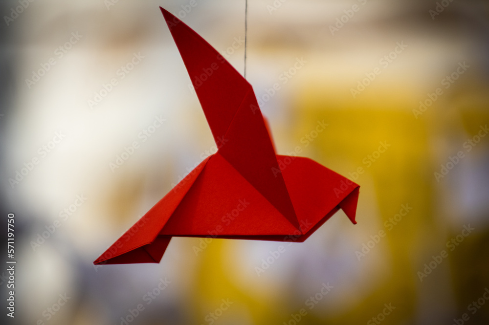 Japanese folded Origami cranes hanging on with strings. Hundreds ...