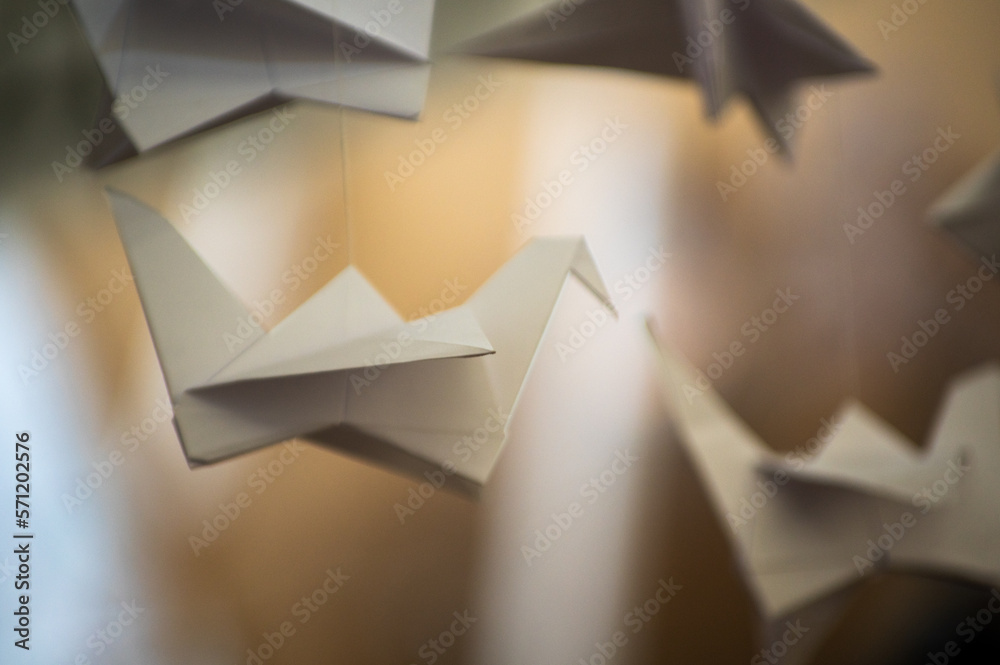 Japanese folded Origami cranes hanging on with strings. Hundreds ...