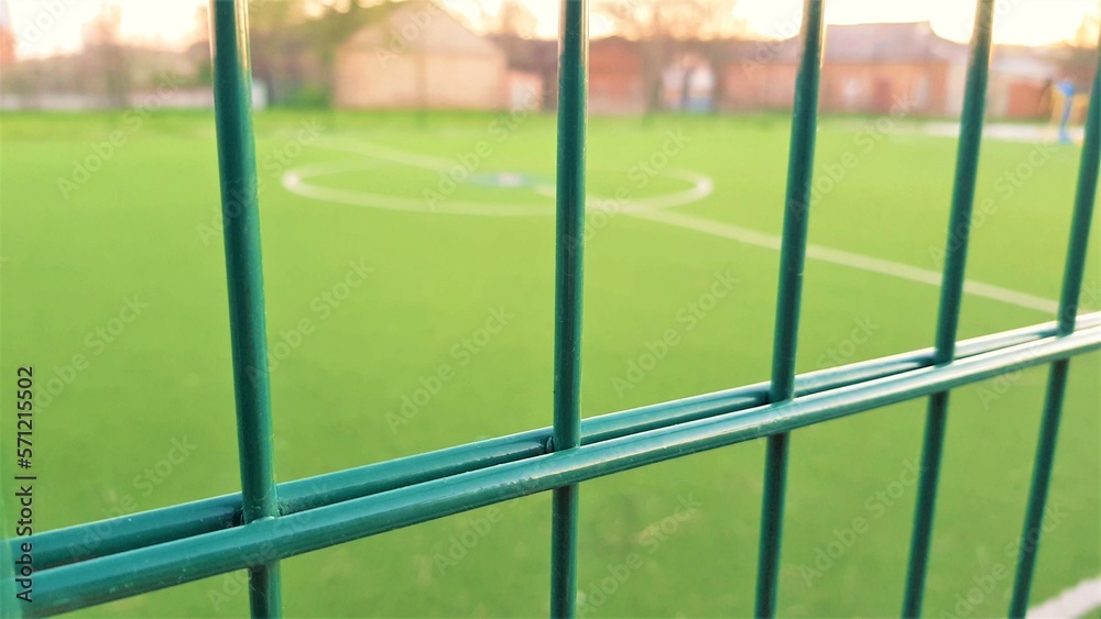 lawn field for playing minifootball behind the green fence mesh Stock ...