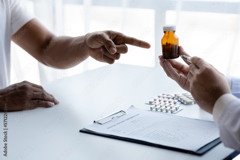 Doctor are recommending medicines to patients after being examined and ...