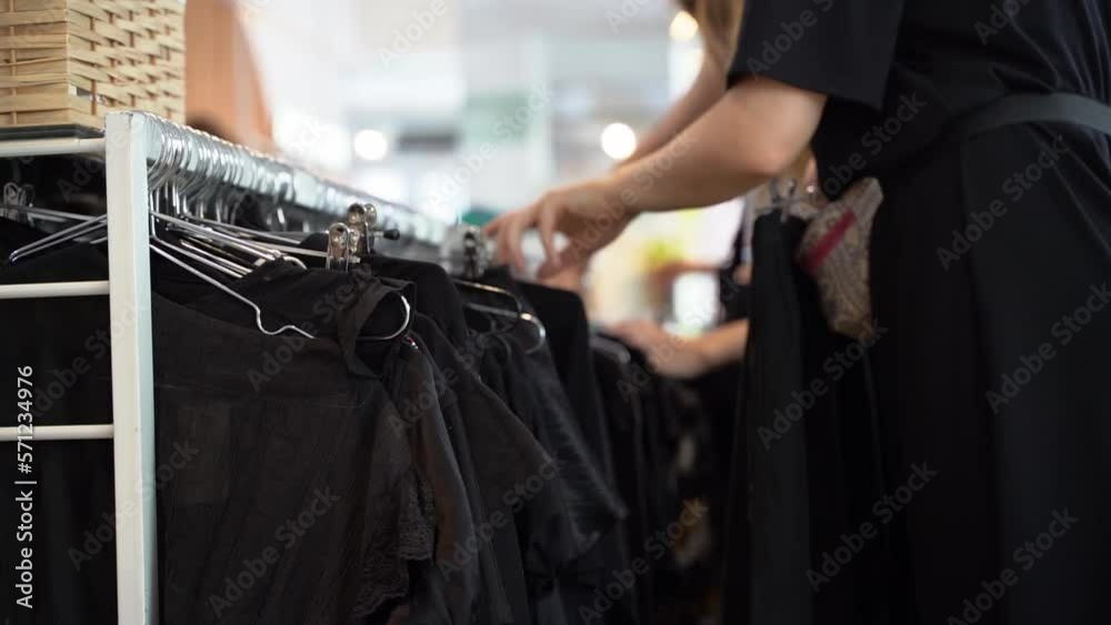 Women's clothing store. Buying and choosing clothes in a shopping mall ...