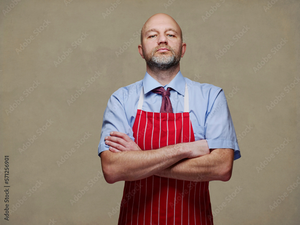 Portrait of a stylish male butcher wearing blue short sleeve shirt and ...