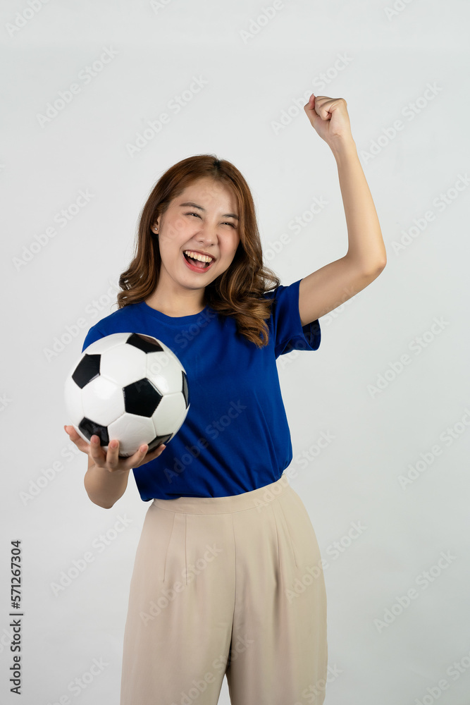 Happy Asian female soccer fan in blue shirt cheering for favorite team ...
