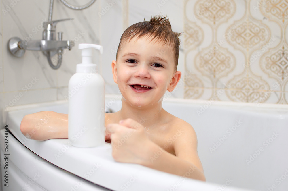 Stockfoto Charming child with soap foam on her hair takes bath ...