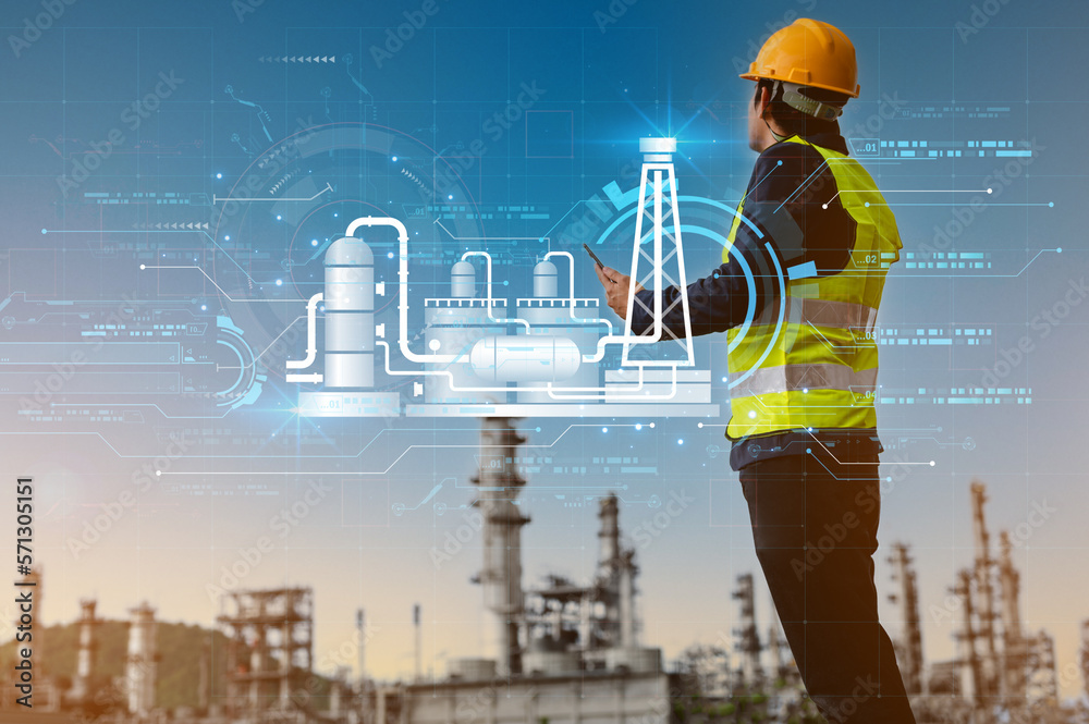 Male engineer wearing a reflective vest and yellow helmet controls the ...