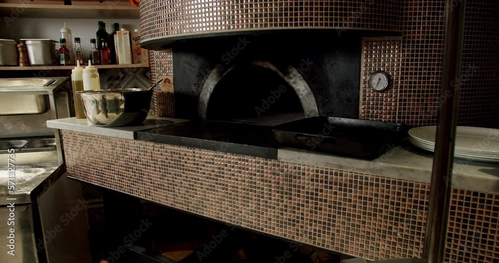 The chef prepares pizza in the restaurant kitchen. Italian Neapolitan ...