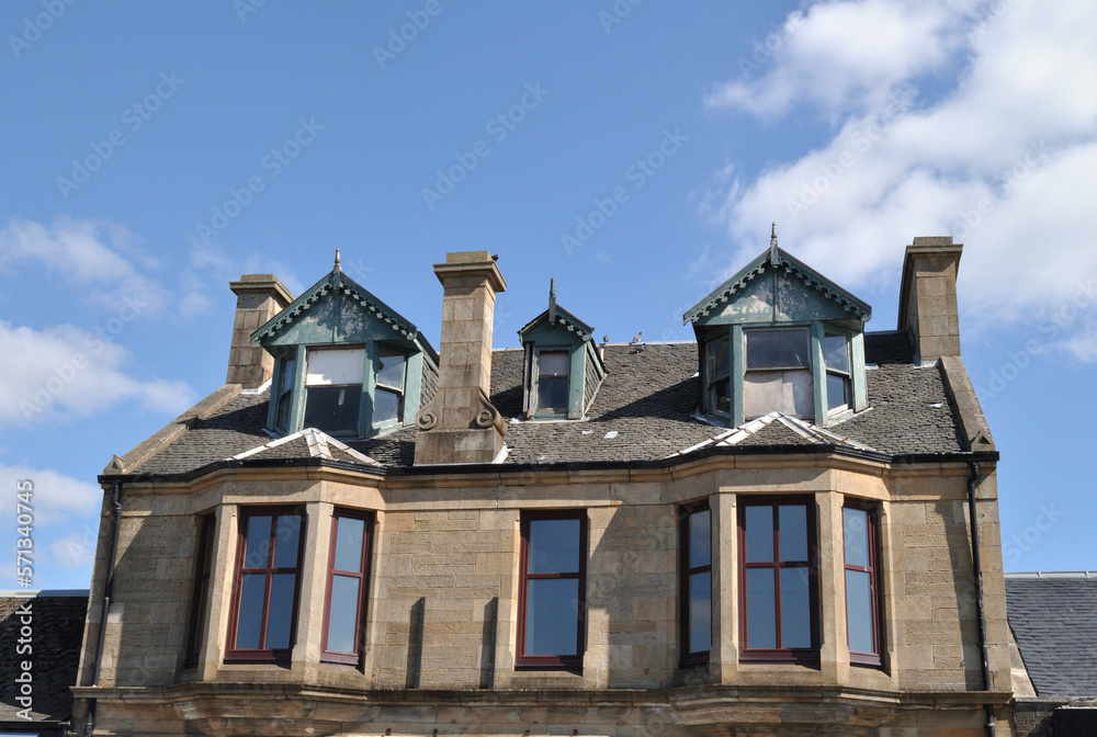 Facade and Roof of Old Stone Building with Dormer Windows and Chimneys ...