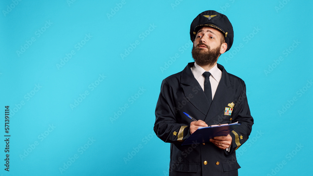 Confident aircrew captain checking list on papers, taking notes with ...