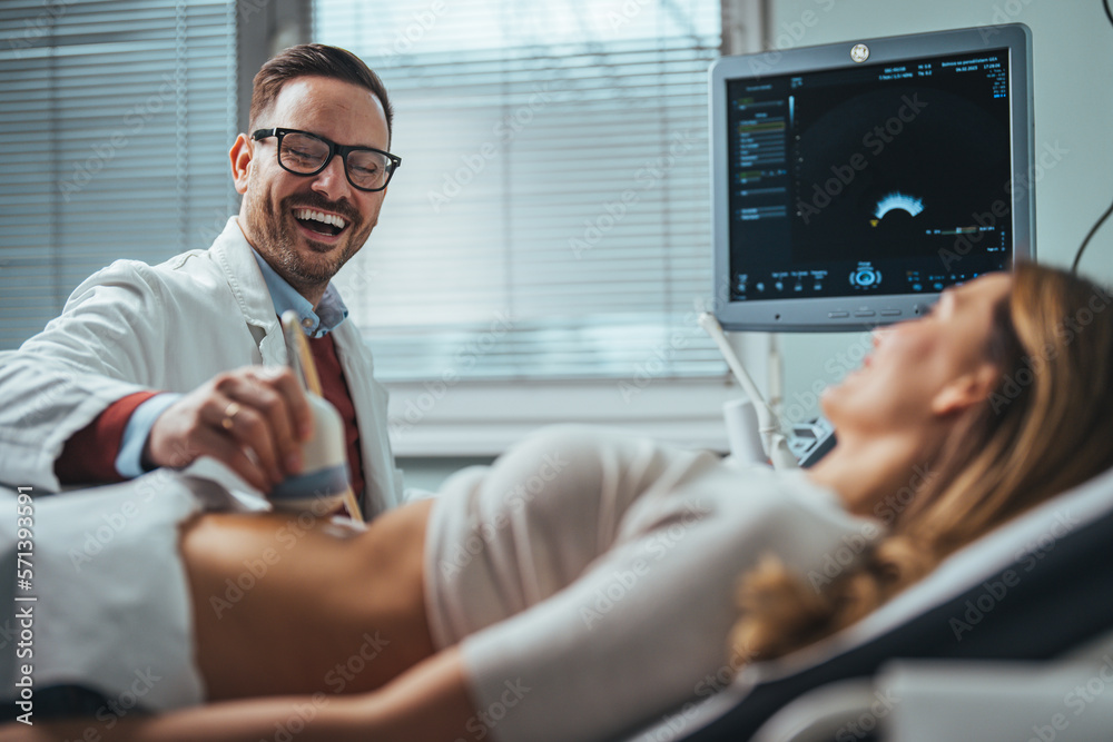 Doctor using ultrasound and screening woman's stomach. Pregnant woman ...