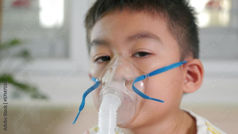 Asian Child using nebulizer mask equipment alone have smoke, Kid boy ...