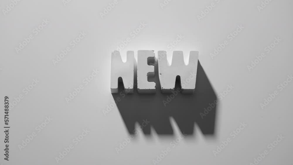 the word NEW appearing letter by letter on white background with ...