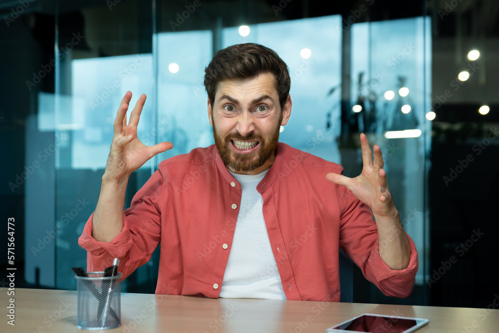 Angry and screaming businessman inside office talking on video call ...