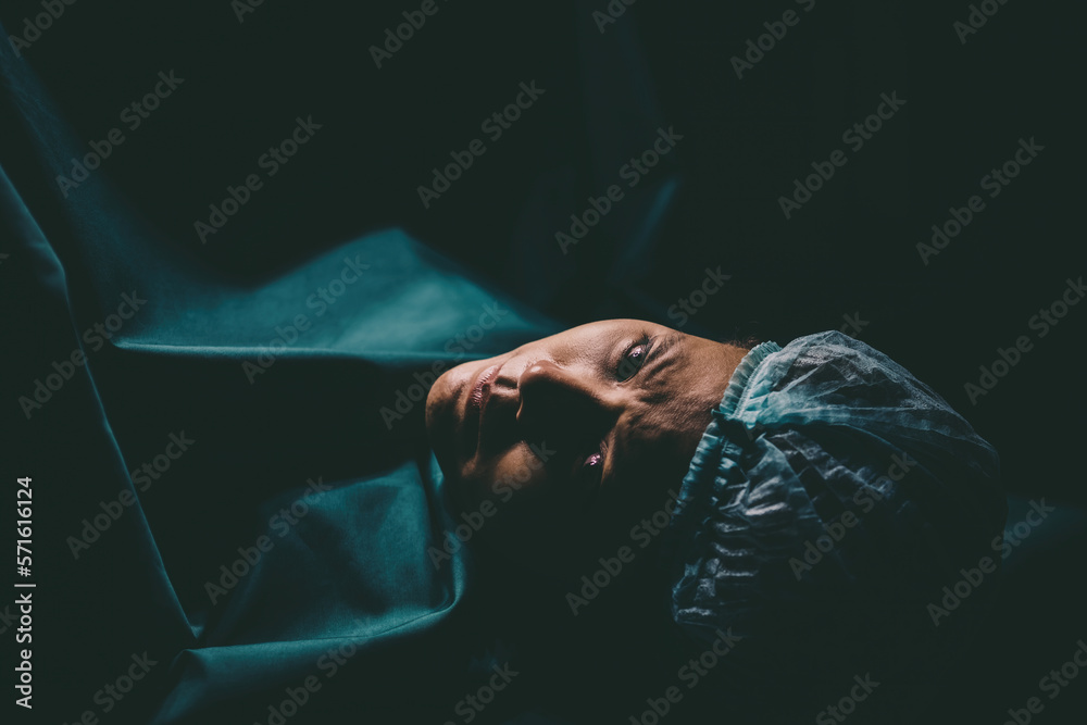 female asian patient wearing net waiting for surgeon to perform surgery ...