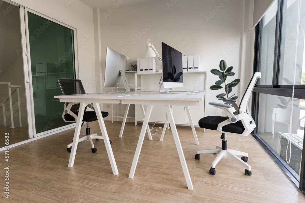 White table and chair with computer monitor and modern file cabinet in ...