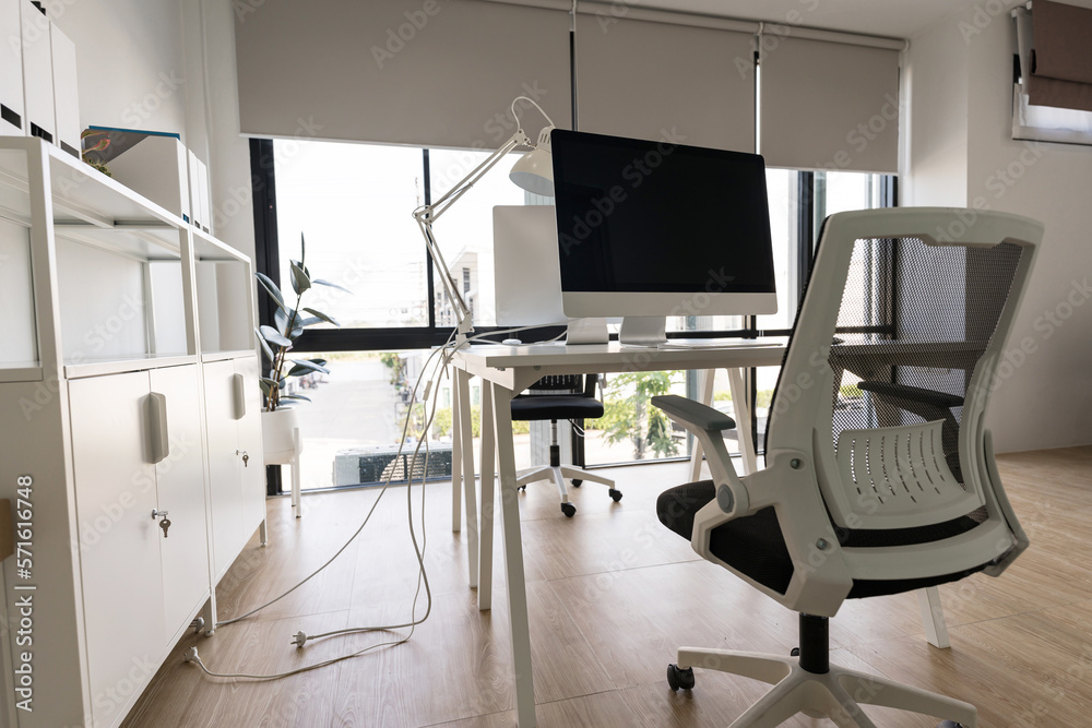 White table and chair with computer monitor and modern file cabinet in ...