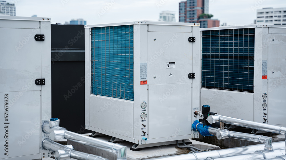 Air conditioner compressor installed on the roof of a building, along ...