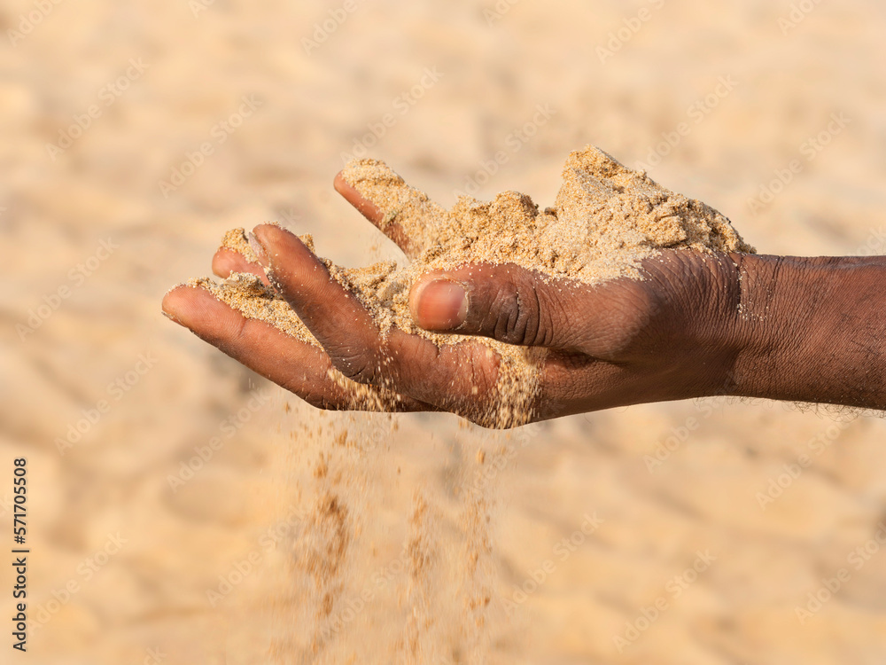 Climate change. Man holding sand in his hand. Symbolic representation ...