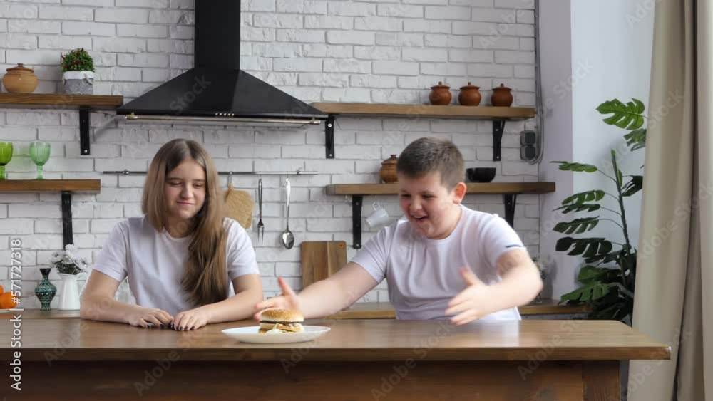 A boy and a girl are arguing over who gets the hamburger. The guy wins ...