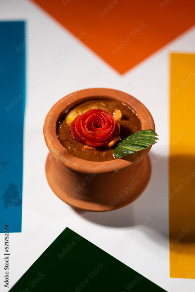 Fried potatoes in a tomato-based curry gravy in a traditional Indian ...