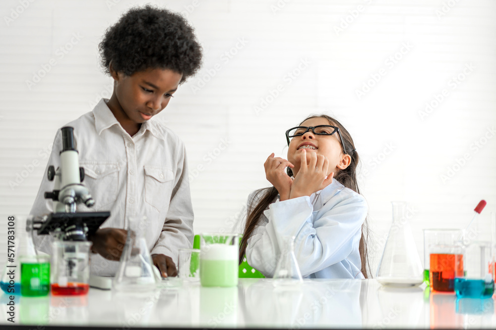 Group of teenage student learn science with teacher and study doing a ...