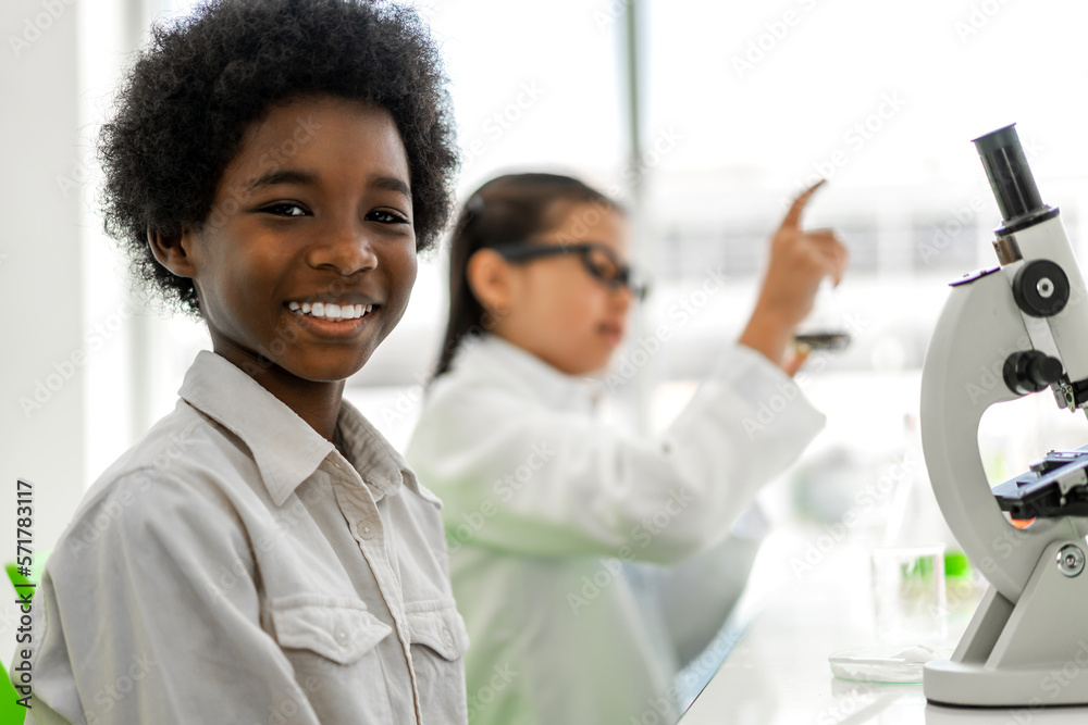 Group of teenage student learn science with teacher and study doing a ...