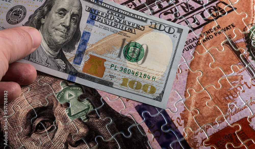 Jigsaw puzzle with a portrait of Benjamin Franklin from a 100 US dollar ...