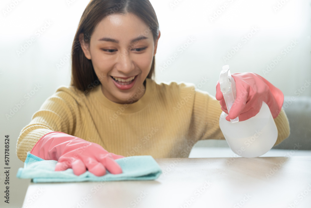 Smile asian young woman, girl working chore, cleaning on table in house ...