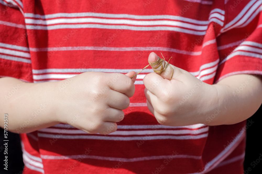 Danger of child wrapping a piece of twine around their finger cutting ...