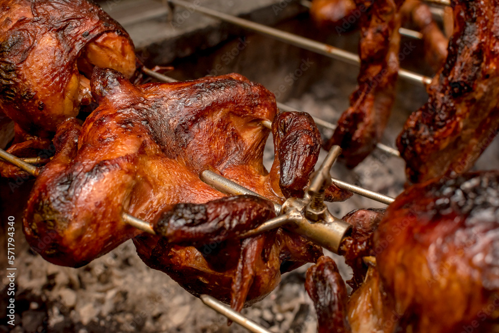 Lechon manok, a Filipino spit-roasted chicken dish. As seen being ...