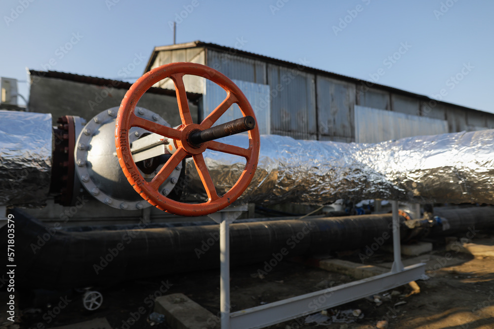 Shallow depth of field details with a metallic pipe valve used to open ...