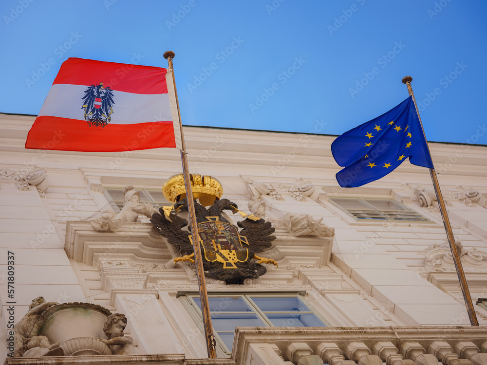 Ancient building with the flag of Austria and the European Union and ...