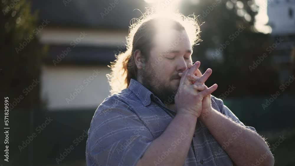 Spiritual young man praying to GOD outdoors in sunlight. A male ...