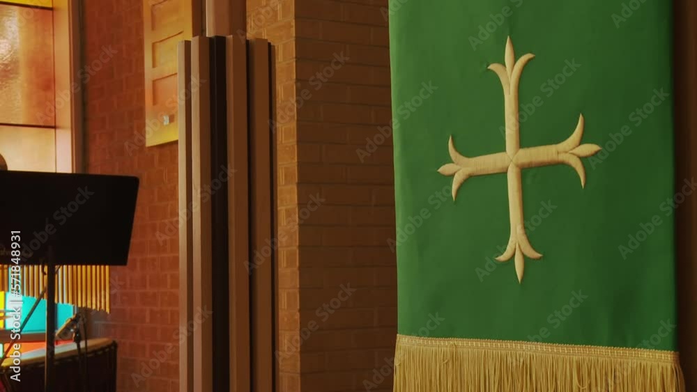 A close dolly shot of a cross crucifix church banner draped across a ...